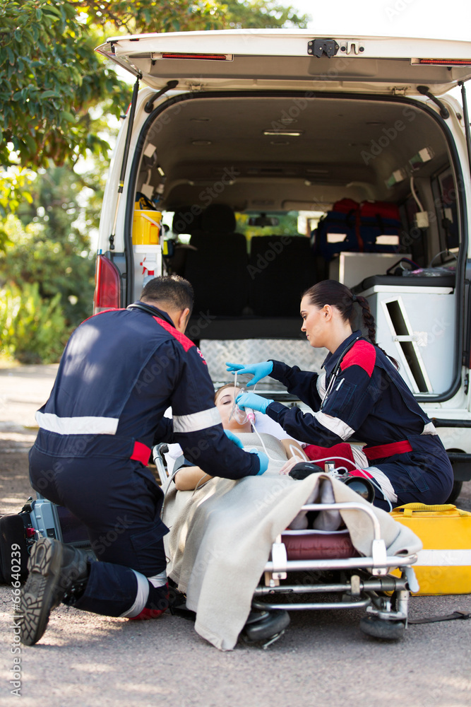 paramedic putting oxygen mask on patient Stock Photo | Adobe Stock