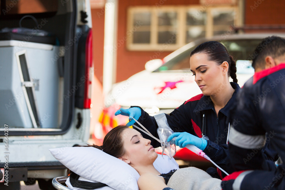 female EMT putting oxygen mask on patient Stock Photo | Adobe Stock