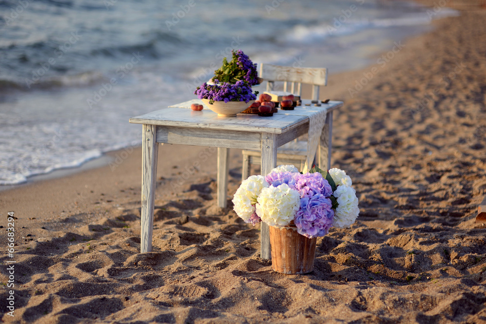 sunrise on the beach in the sand is a table with color and peach Stock ...