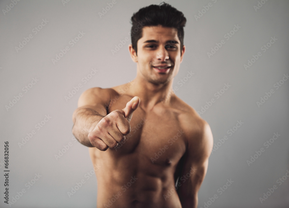 Happy bodybuilder showing thumbs up sign Stock Photo | Adobe Stock