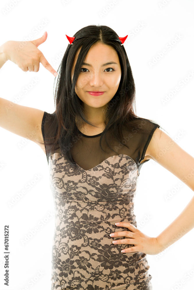 Asian young woman dressed up as a devil and pointing herself Stock ...