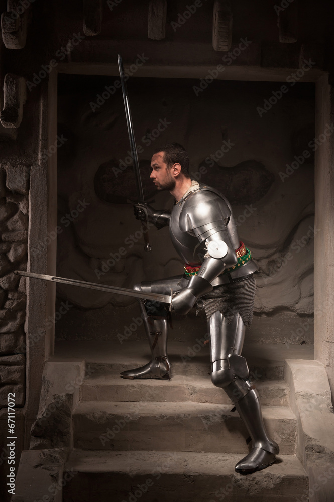 Medieval warrior posing on steps of ancient temple Stock Photo | Adobe ...