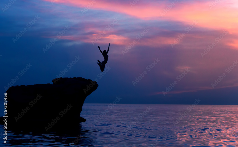 Brave girl jumping from rocks Stock Photo | Adobe Stock