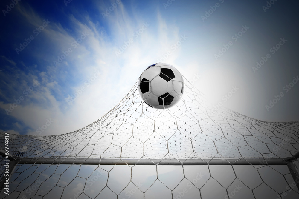 Soccer football in Goal net with Blue sky Stock Photo | Adobe Stock
