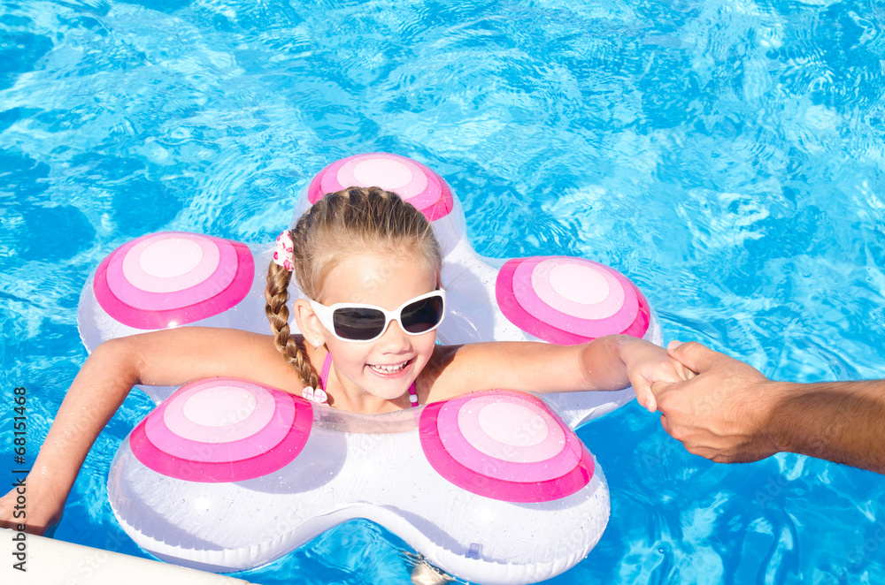 Father giving hand to little girl in swimming pool Stock Photo | Adobe ...