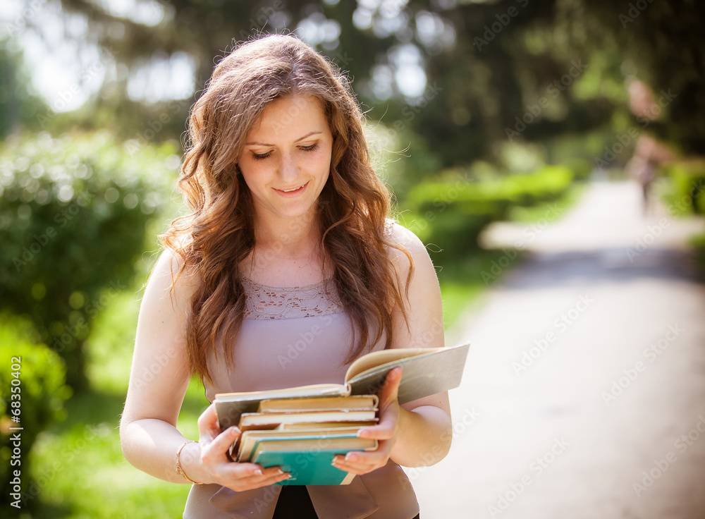 student with a book on street Stock-Foto | Adobe Stock