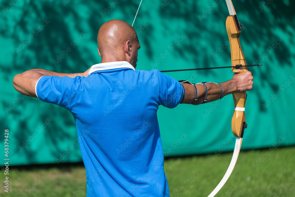 archer at shooting range with bow and arrow Stock Photo | Adobe Stock