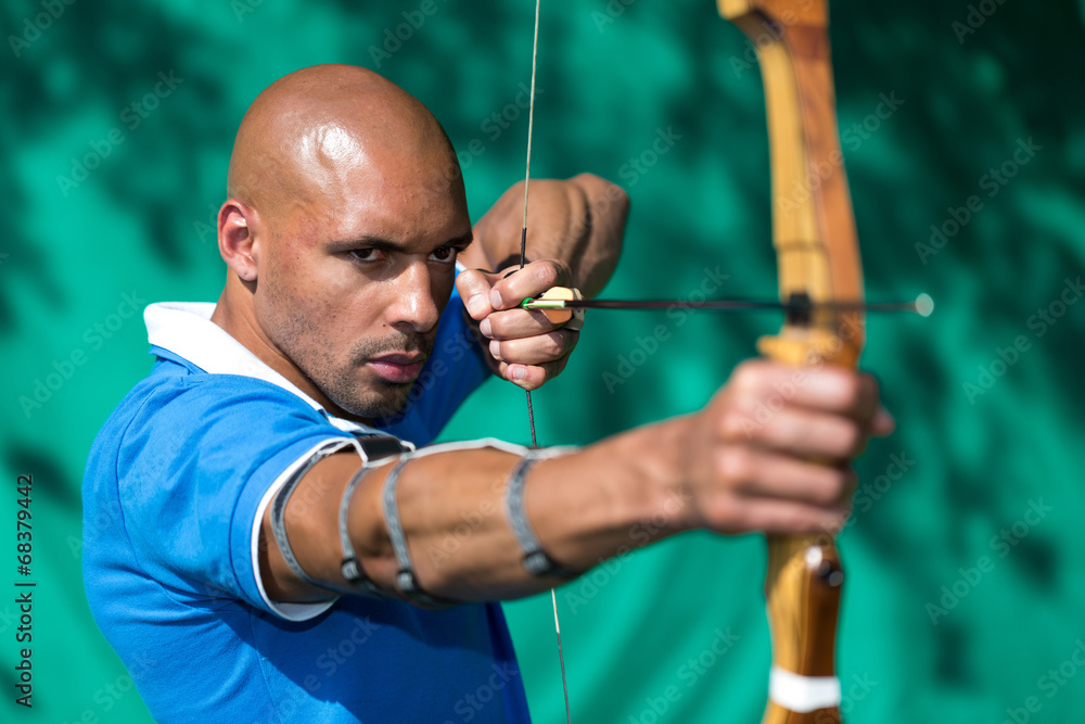 archer at shooting range with bow and arrow Stock Photo | Adobe Stock