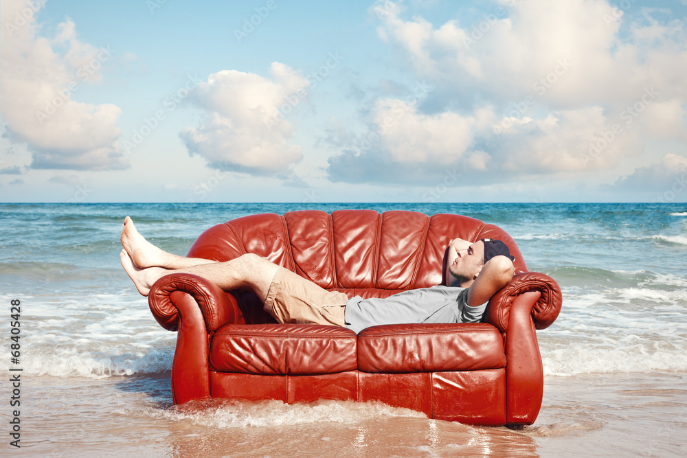 man resting in leather couch on the beach Stock Photo | Adobe Stock