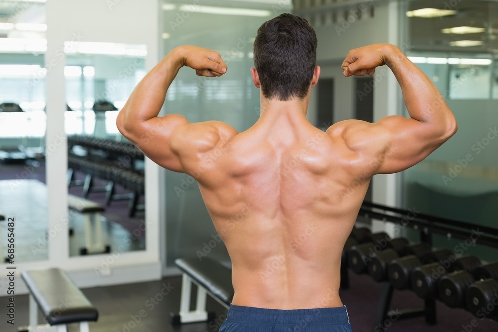Rear view of a muscular man flexing muscles Stock Photo | Adobe Stock