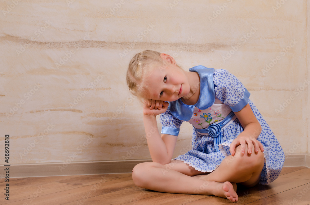 Cute young girl sitting in corner Stock Photo | Adobe Stock