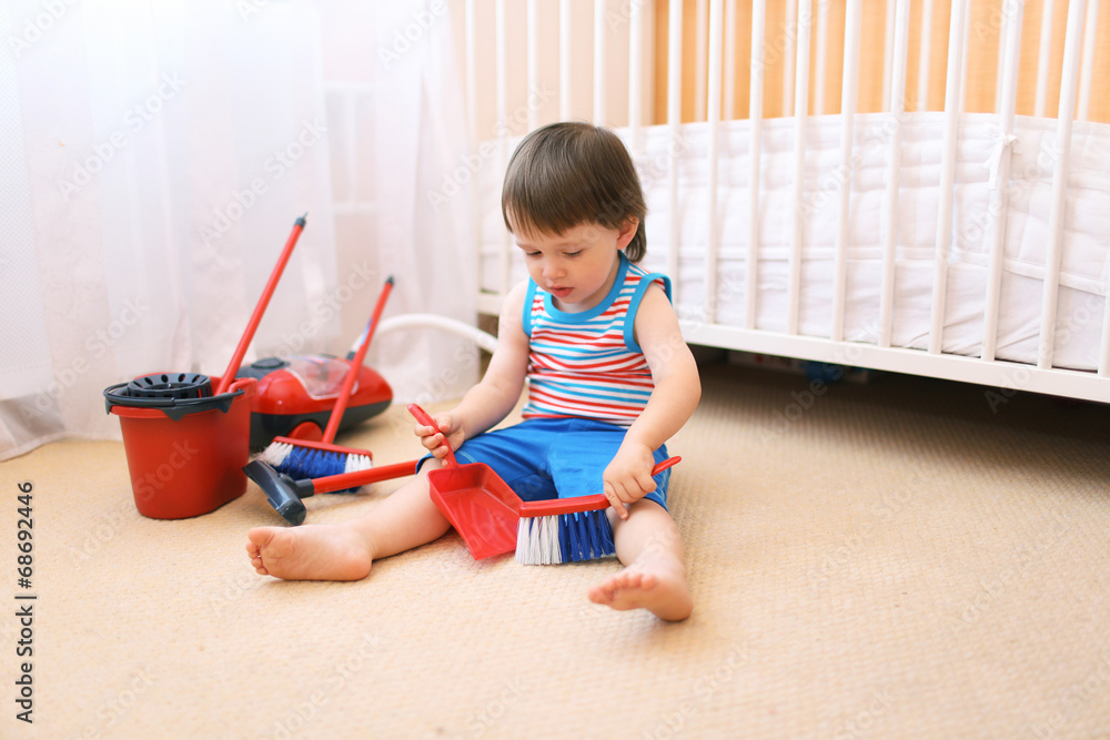 lovely baby cleaning his room Photos | Adobe Stock