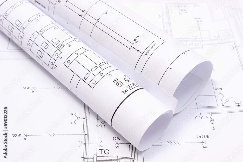 Rolled electrical diagrams on construction drawing of house Stock Photo ...