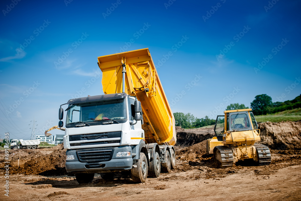 dumper truck and bulldozer at highway road construction site Stock ...