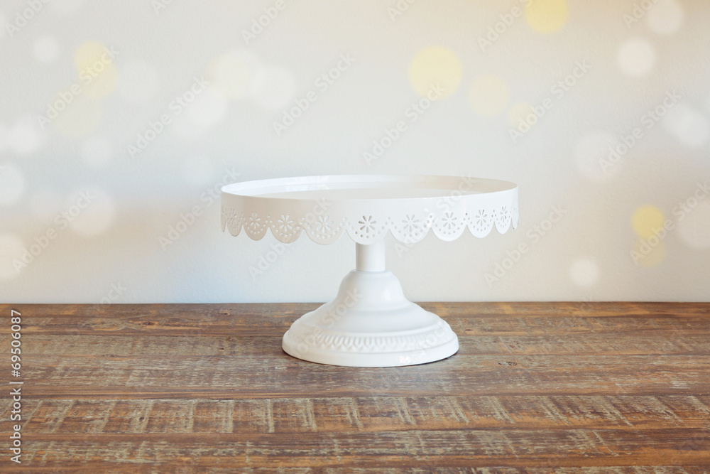 Cake plate on vintage wooden table over bokeh background Stock Photo ...
