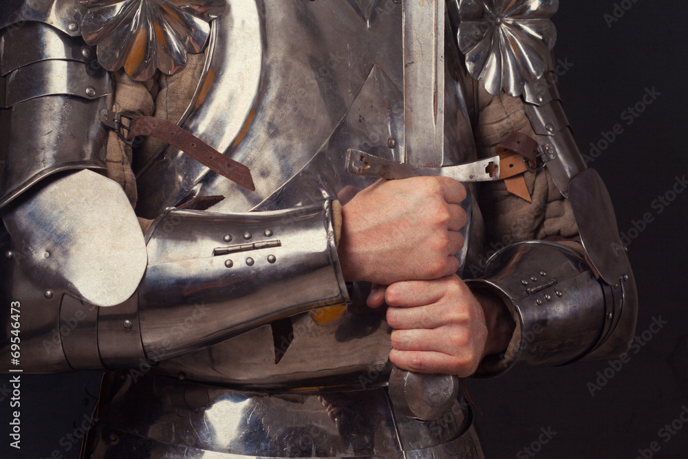 knight wearing armor and holding two-handed sword Stock Photo | Adobe Stock