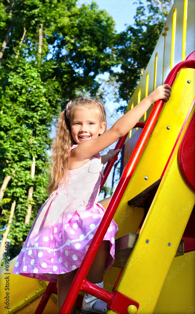 Little girl is climbing up on ladder in playground equipment Stock ...