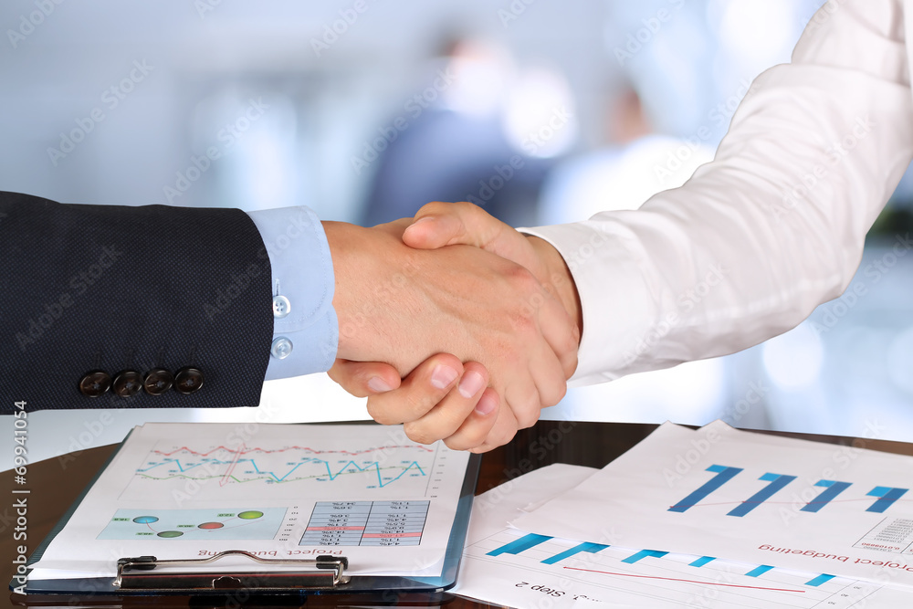 Close-up image of a firm handshake between two colleagues in of Stock ...