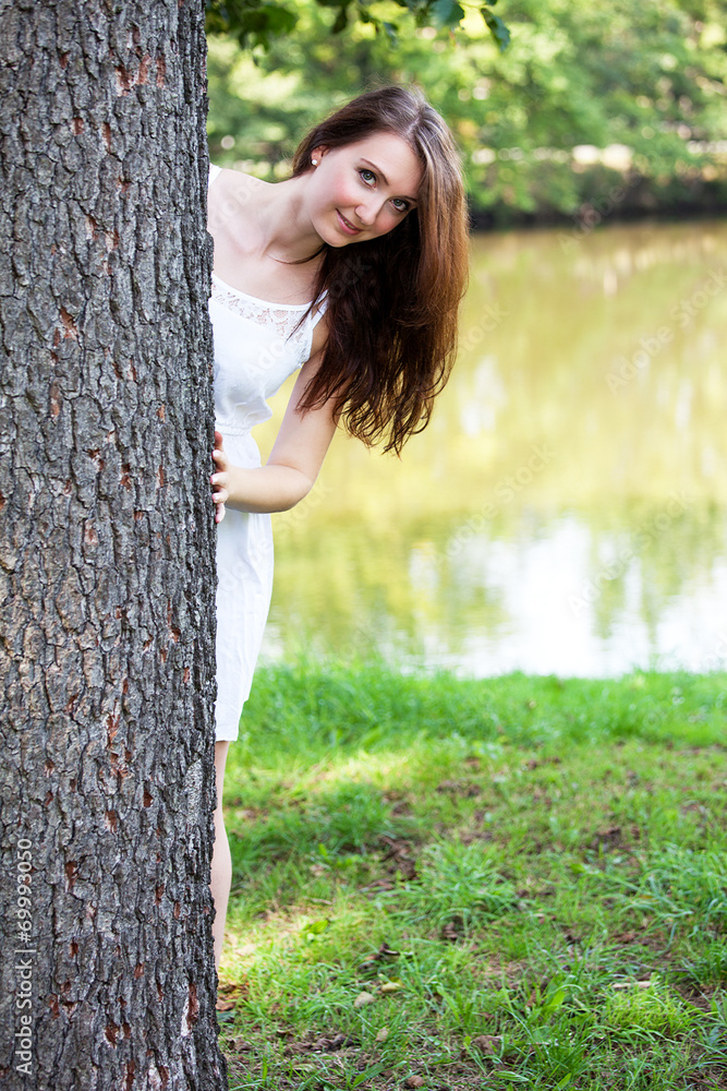 Woman Hiding Behind Tree