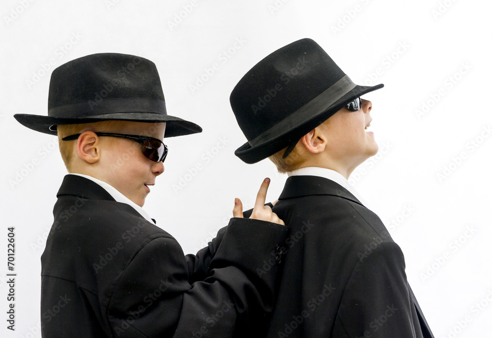 Twin boys dressed as gangsters. Stock Photo | Adobe Stock