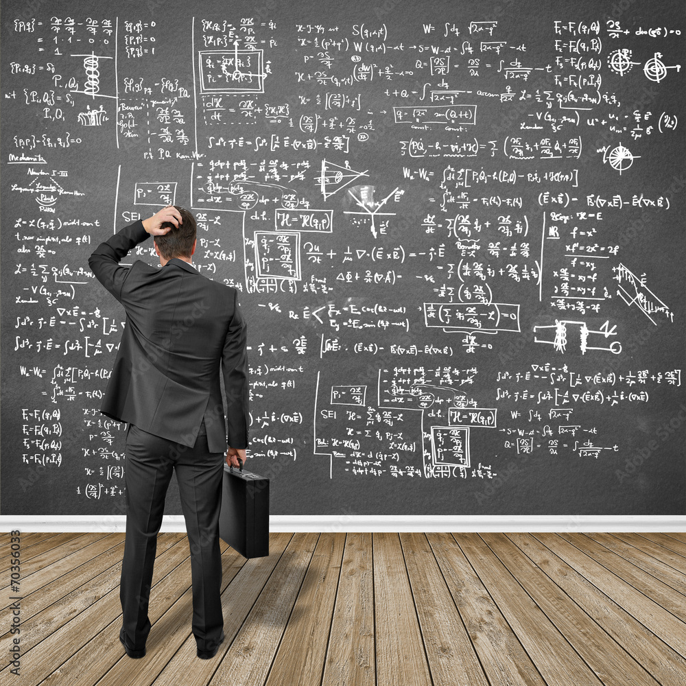 Businessmann steht vor Tafel mit Formeln Stock Photo | Adobe Stock