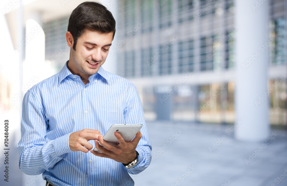 Young man using his tablet Stock Photo | Adobe Stock