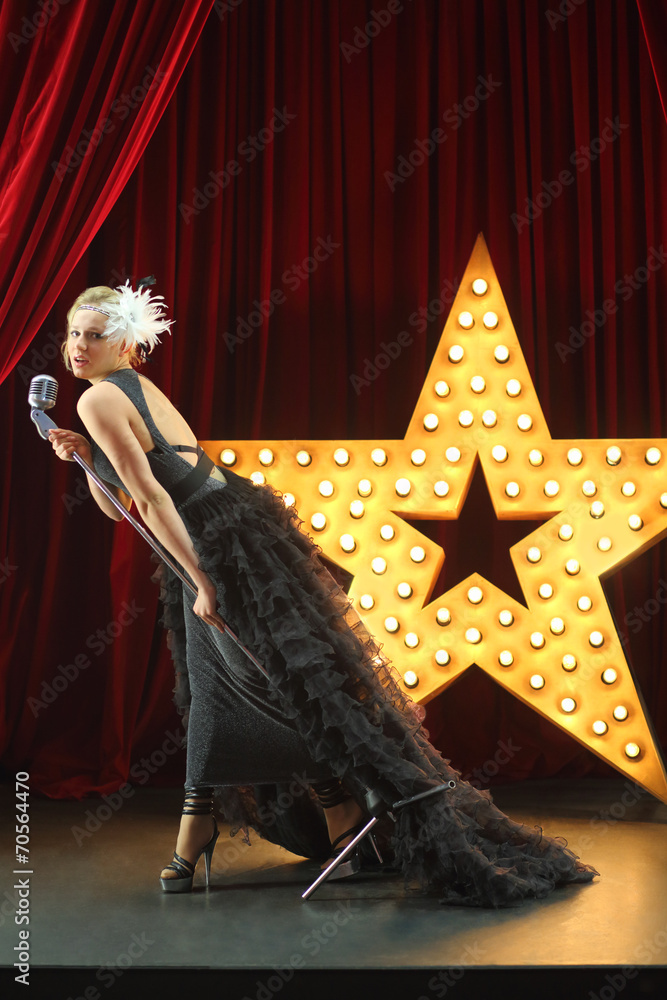 Beautiful woman dressed as bat singing in microphone on stage Stock ...