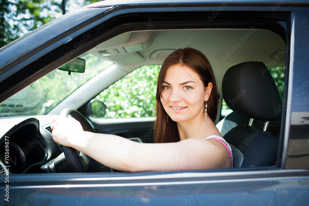 Beautiful young woman/girl/teenager driving her first new car after car ...