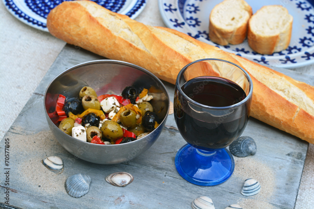 Een schaaltje olijven met stokbrood en rode wijn. Stock Photo | Adobe Stock