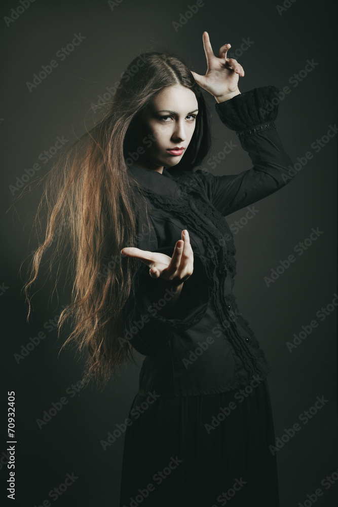 Beautiful young witch casting a spell Stock Photo | Adobe Stock