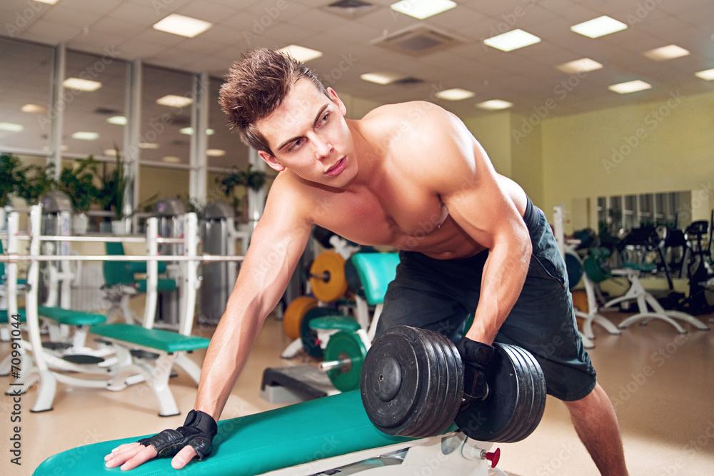 Muscular man working his biceps Stock Photo | Adobe Stock