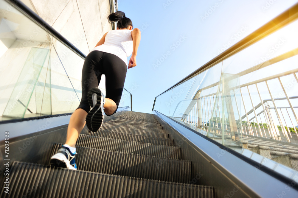 Runner athlete running on escalator stairs. Stock Photo | Adobe Stock