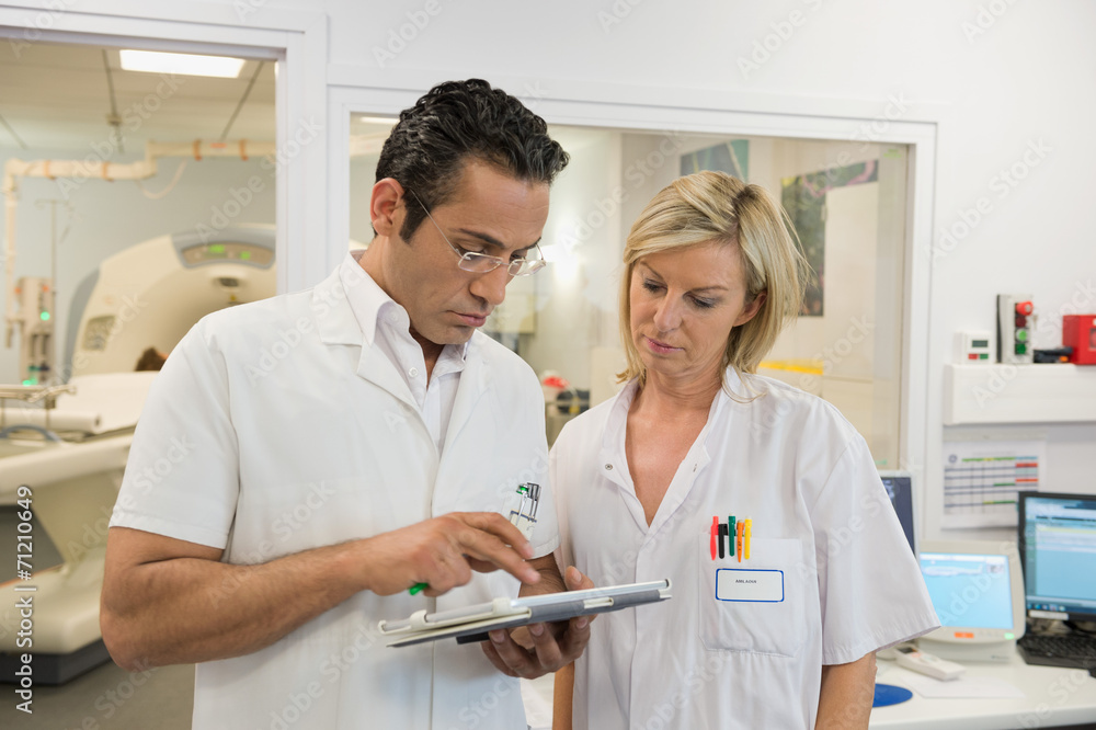 Doctors examining MRI scan report in medical scan room Stock Photo ...