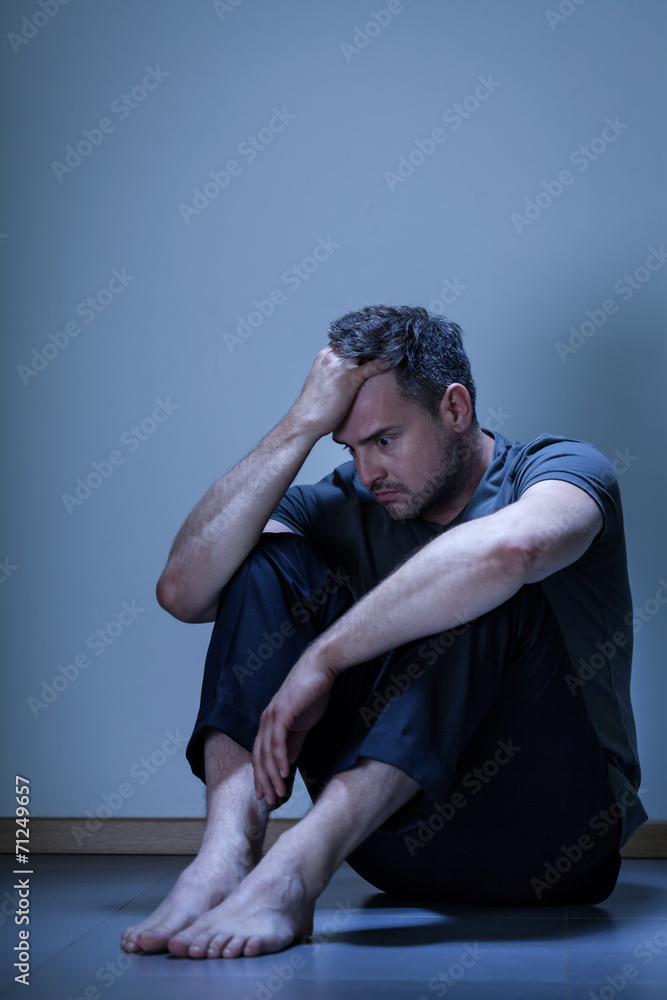 Depressed man sitting on the floor Stock-Foto | Adobe Stock