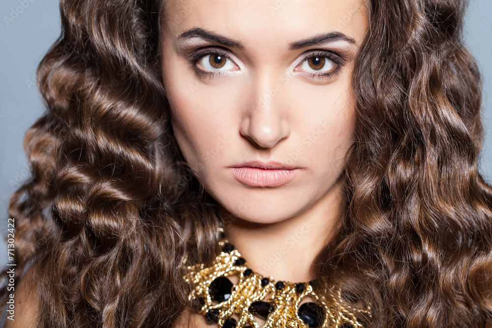 Fashion model with long curly hair. Fashion model in studio Stock Photo ...
