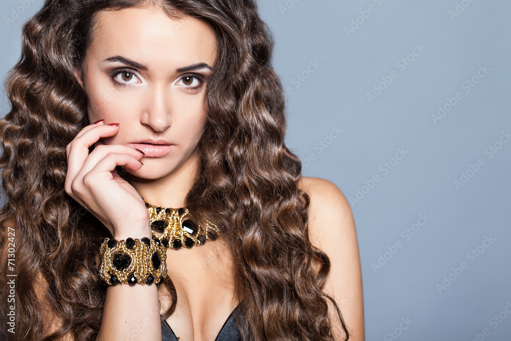 Fashion model with long curly hair. Fashion model in studio Stock Photo ...
