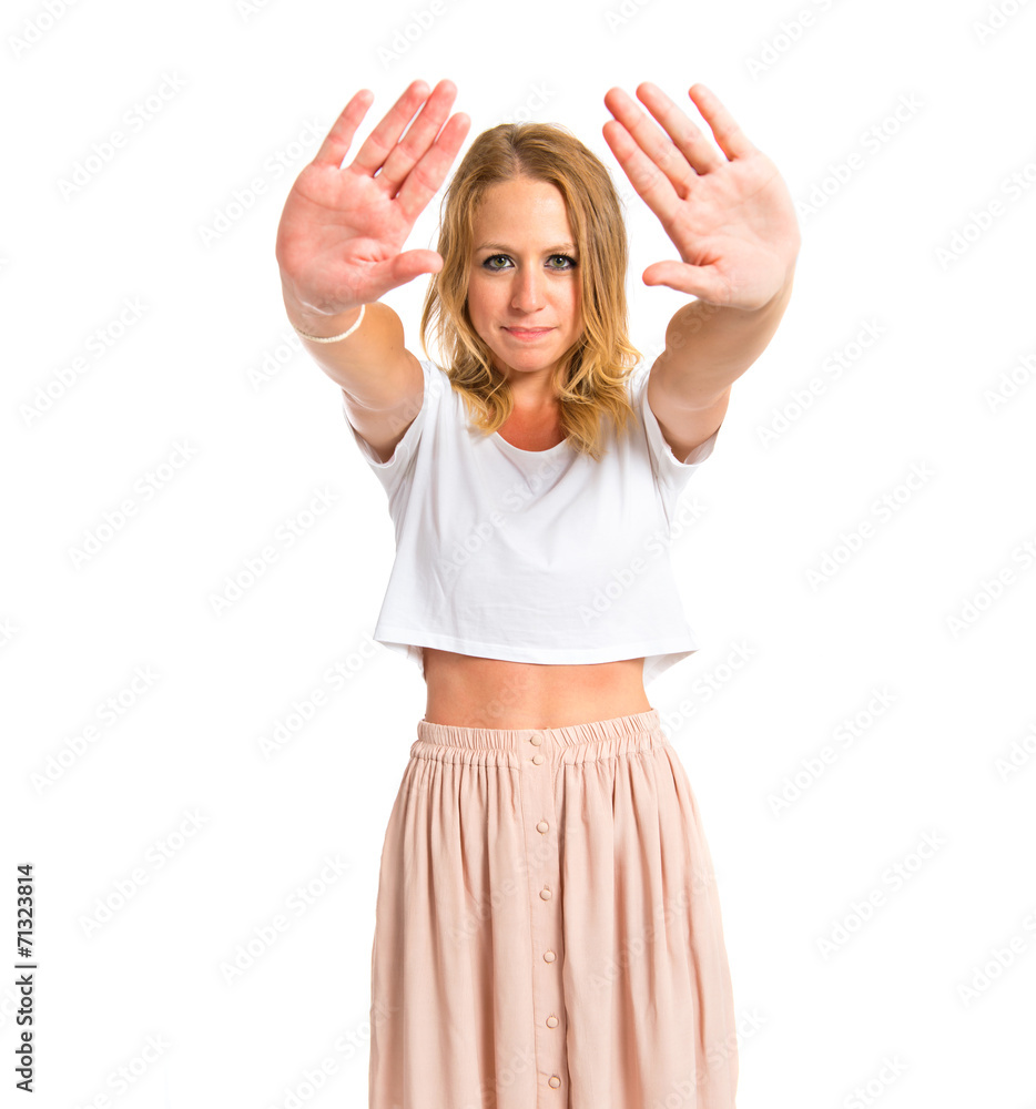 Girl making stop sign over white background Stock Photo | Adobe Stock