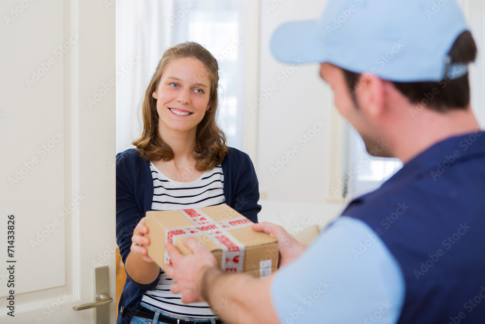 Delivery man handing over a parcel to customer Stock Photo | Adobe Stock