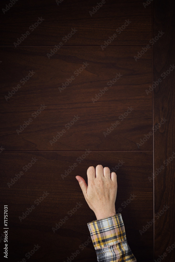 Hand is knocking on the door Stock Photo | Adobe Stock