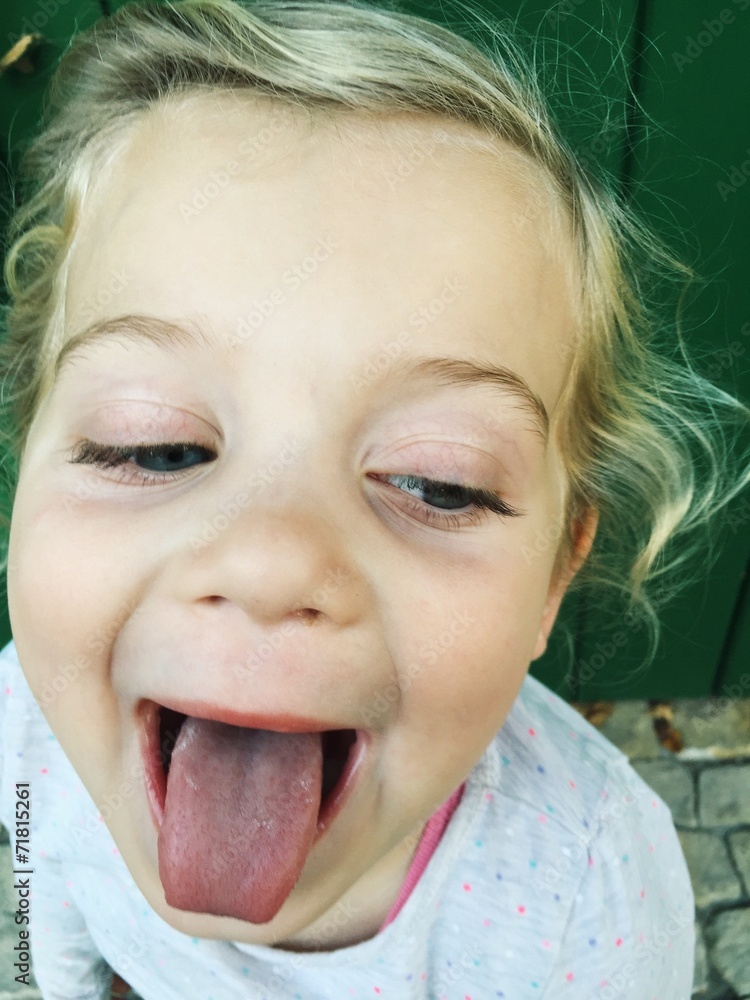 Mädchen streckt Zunge raus Stock Photo | Adobe Stock