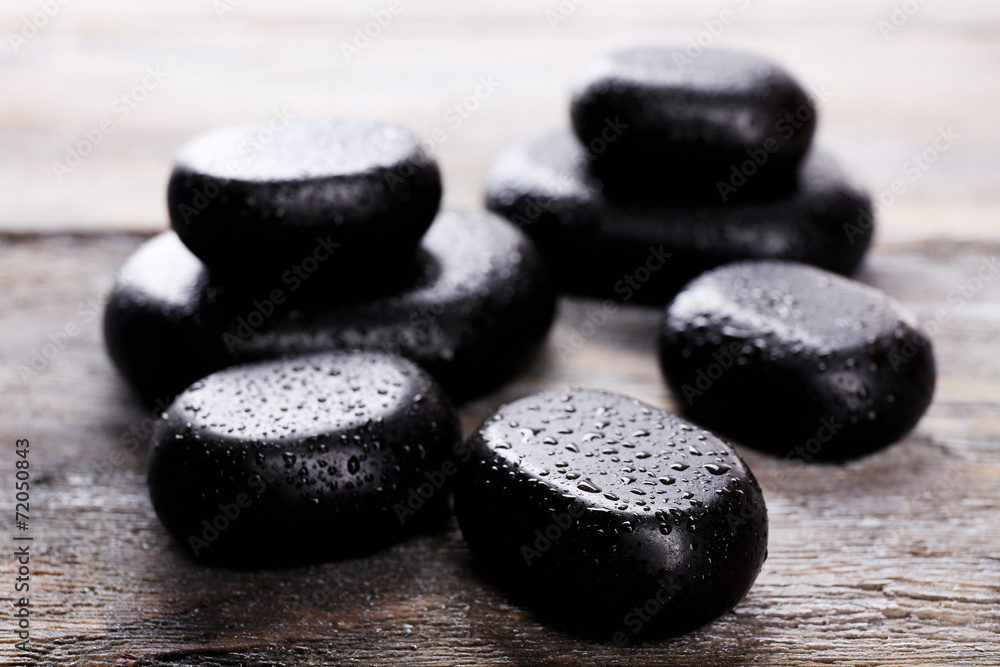Spa stones with drops on wooden background Stock Photo | Adobe Stock
