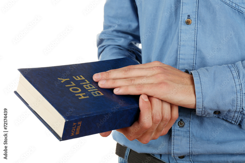 Man holding Bible isolated on white Stock Photo | Adobe Stock