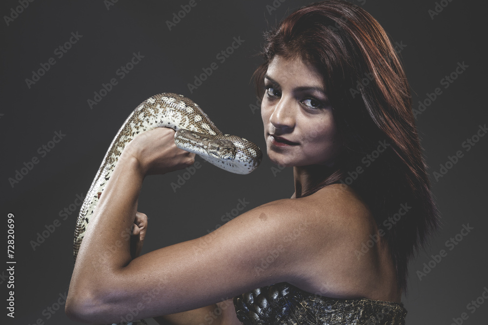 Sexy warrior tattooed woman with big snake and iron corset Stock Photo ...