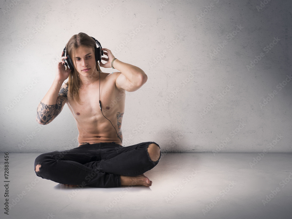 Muscular man shirtless listening to music on headphones Stock Photo ...