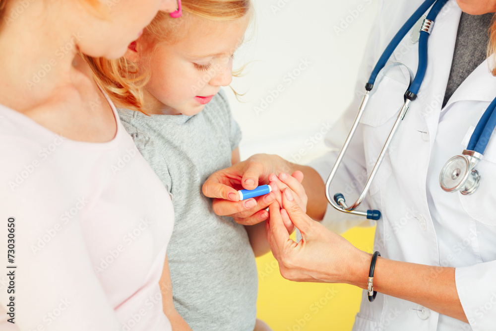 Doctor taking blood test from small patient. Stock Photo | Adobe Stock