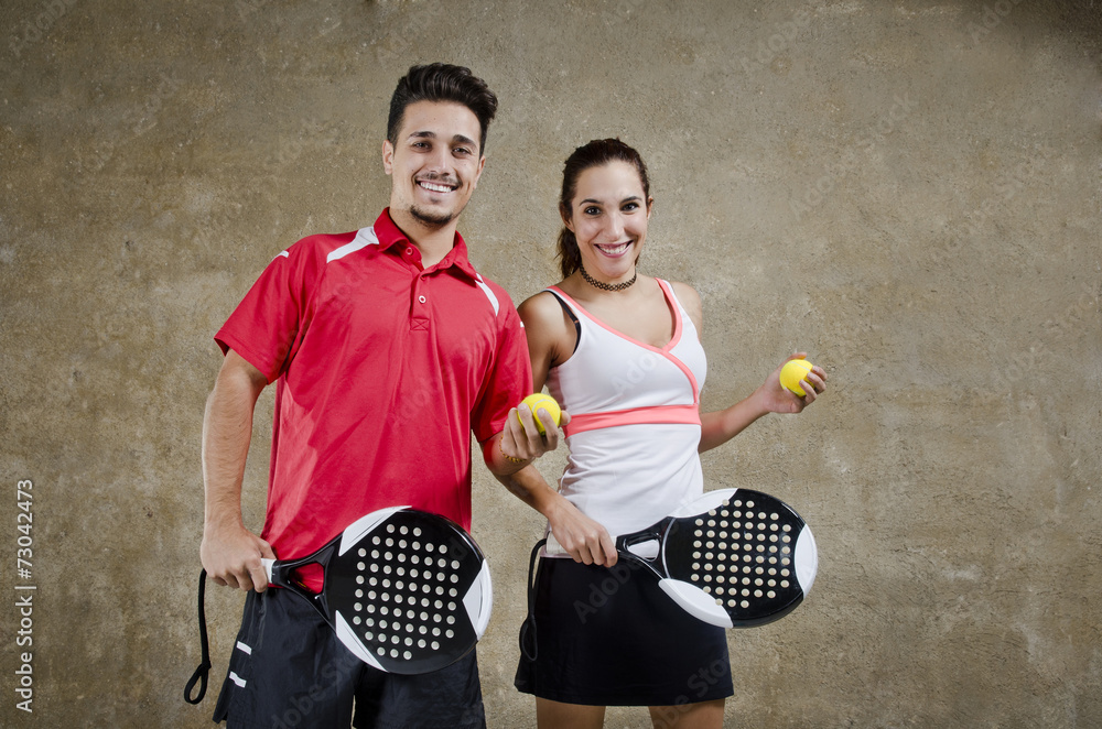 Paddle tennis couple posing in concrete court Stock Photo | Adobe Stock