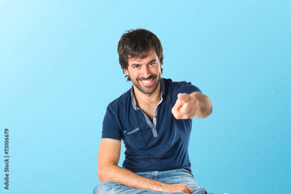 Man pointing to the front over blue background Stock Photo | Adobe Stock