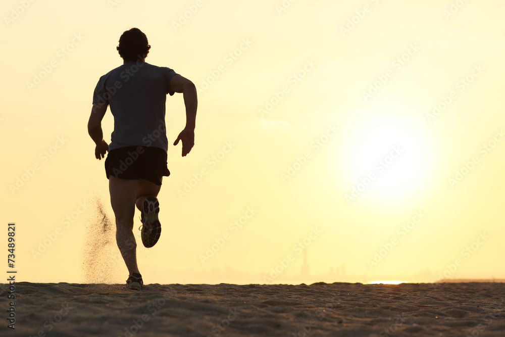Back view silhouette of a runner man running on the beach Stock Photo ...