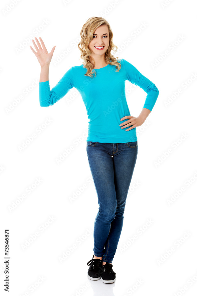 Beautiful woman waving to the camera Stock-Foto | Adobe Stock