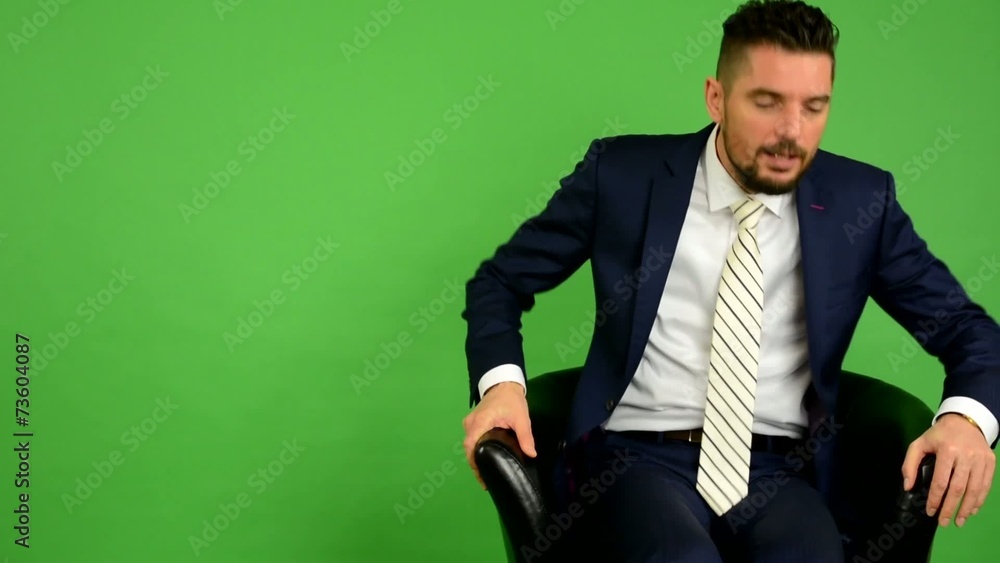 business man goes to sit down and smiles - green screen - studio Stock ...